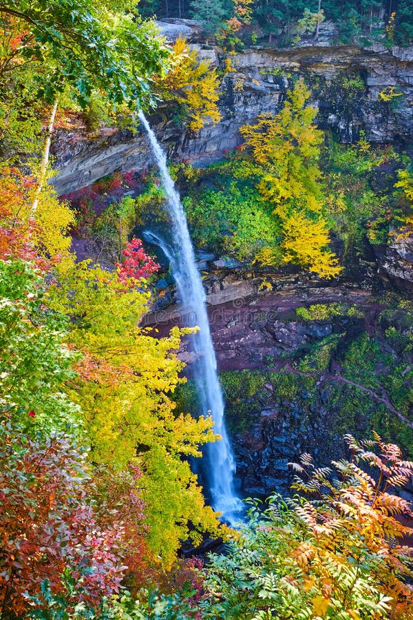 Stunning Tall Waterfall Over Cliffs is Surrounded by Colorful Peak Fall ...