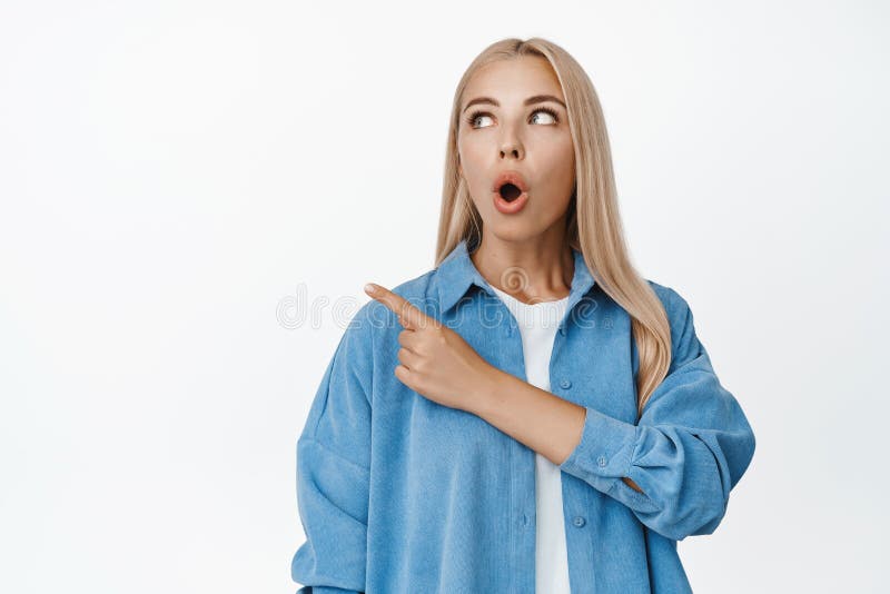 Image of Surprised Blond Girl Say Wow, Pointing and Looking at Upper ...