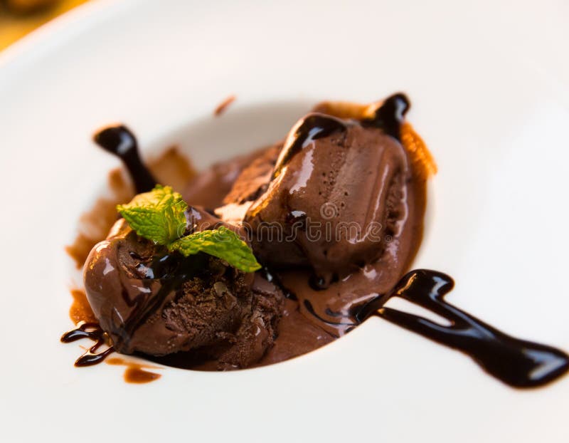 Tasty Cold Chocolate Ice Cream Served at Plate with Chocolate Cream and ...