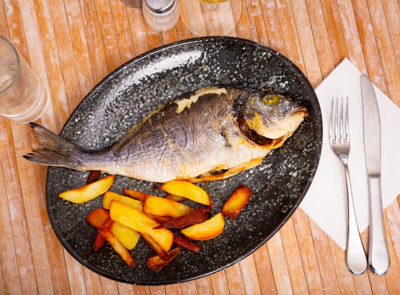 Baked Fish Called Dorada, with an Appetizing of Fried Potatoes Stock ...