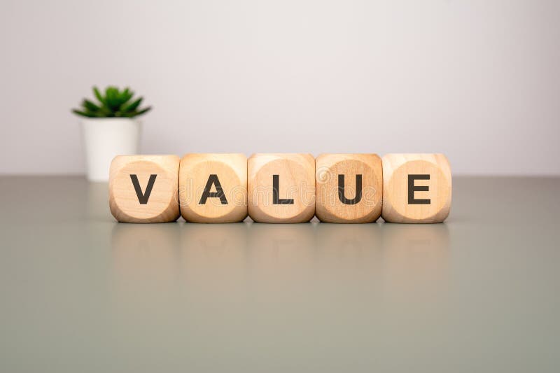 In the Image, There are Wooden Blocks that Spell Out Value while a ...