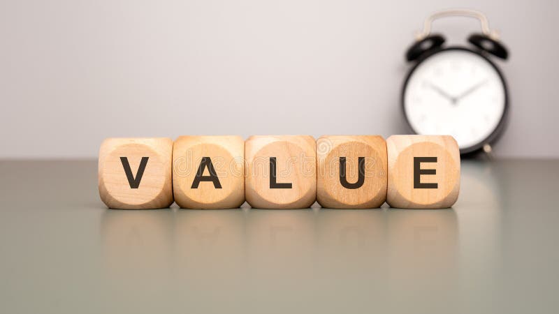 In the Image, There are Wooden Blocks that Spell Out Value while a ...