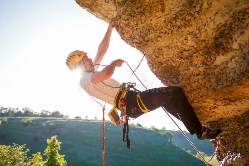 Image of Tourist Man in Helmet Clambering Up Stock Photo - Image of ...