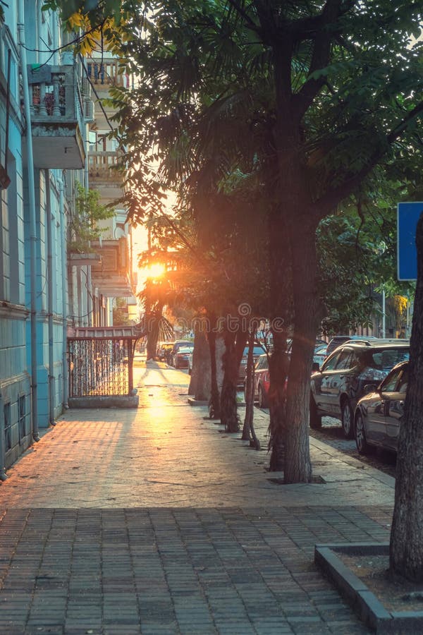 Image of a Town Street with Rising Sun Background Stock Image - Image ...
