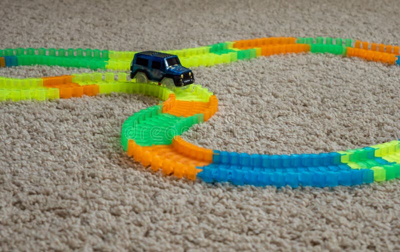 Image of Toy Car Track with Car and Colorful Track Elements on Carpet ...