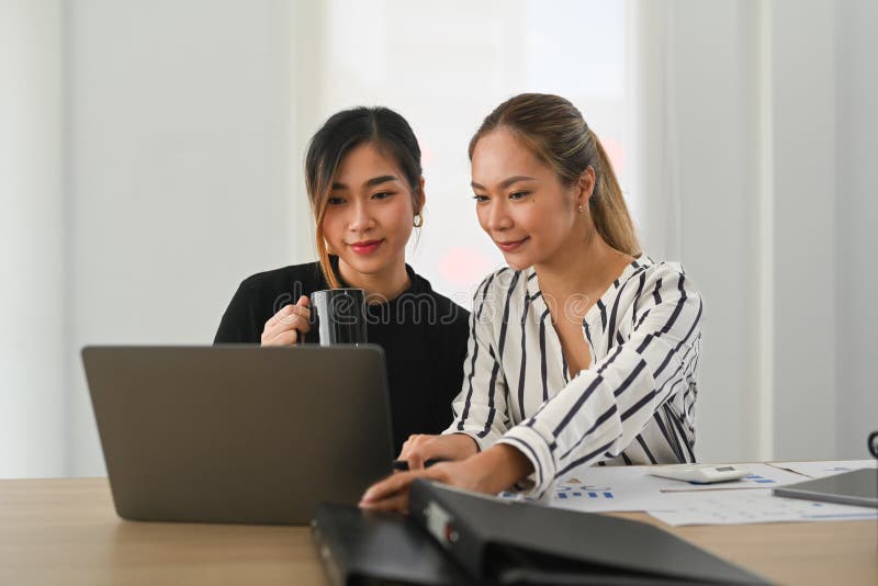 Image of Two Business Colleagues Comparing Corporate Income for ...