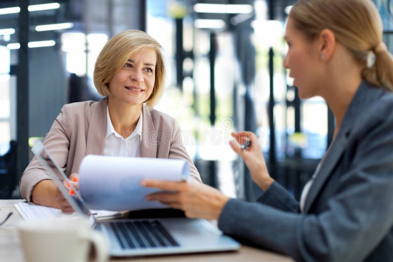 Image of Two Business Women Working in the Office with Documents. Stock ...