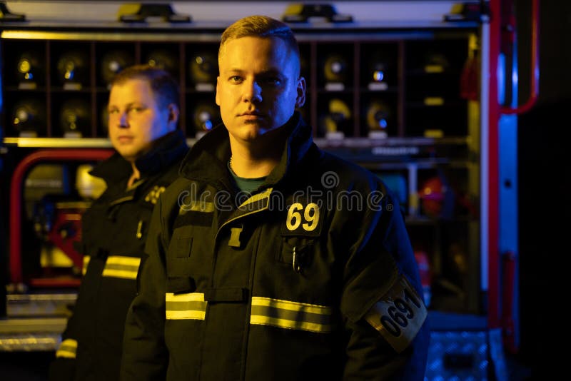 Image of Two Firefighter Looking into Camera Near Fire Truck Stock ...
