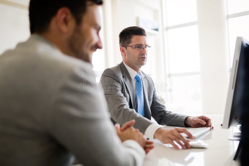 Image of Two Handsome Businessmen Using Computer at Meeting Stock Image ...