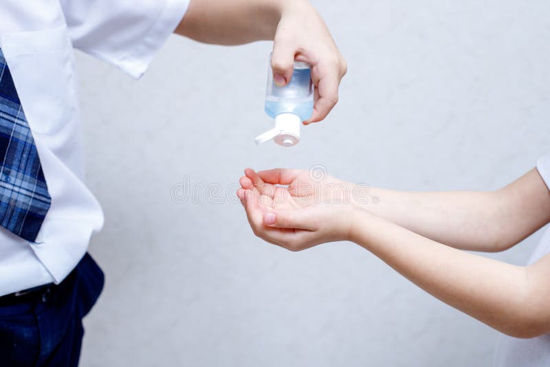 An Image of Two Pairs of Hands, in the Same Hands a Disinfectant ...
