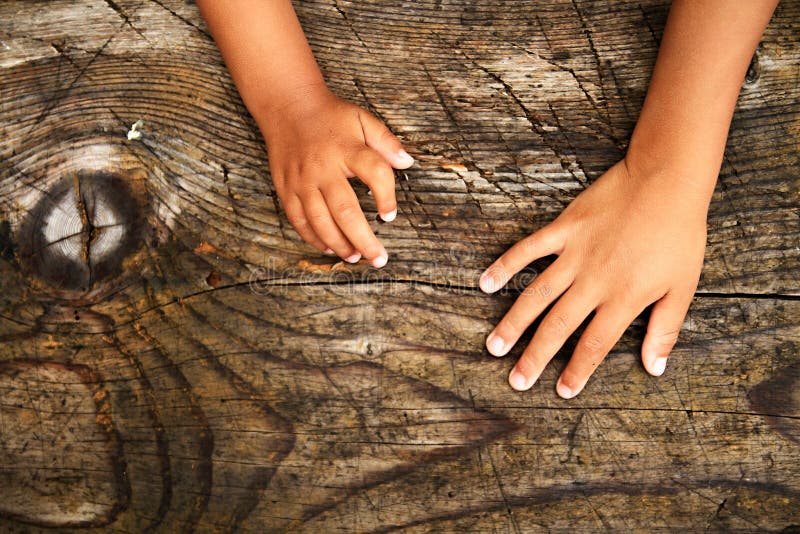 Two small hands on a table stock image. Image of concept - 121968449