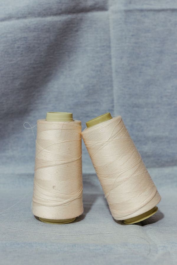 Image of Two White Spools of Thread Placed Side by Side Stock Photo ...
