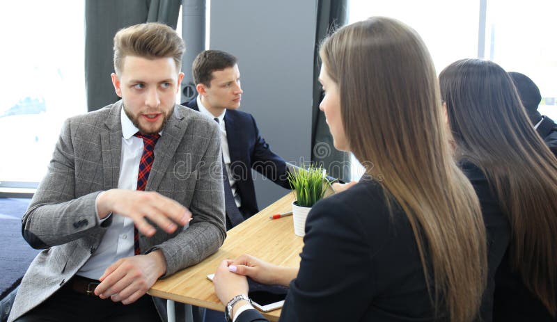 Image of Two Young Business People Interacting at Meeting in Office ...