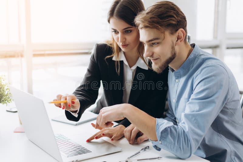Image of Two Young Business Workers Working Together on Project at ...