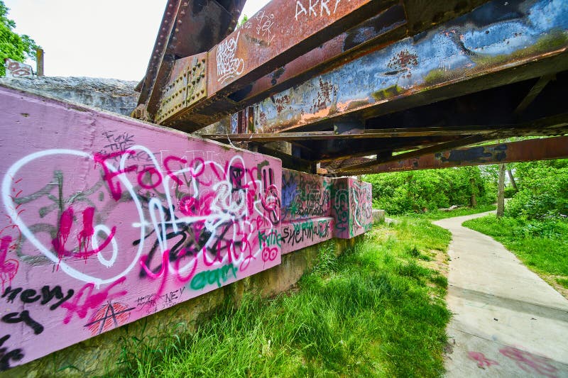 Underside of Train Bridge with Graffiti on Pink Wall and Corroding ...