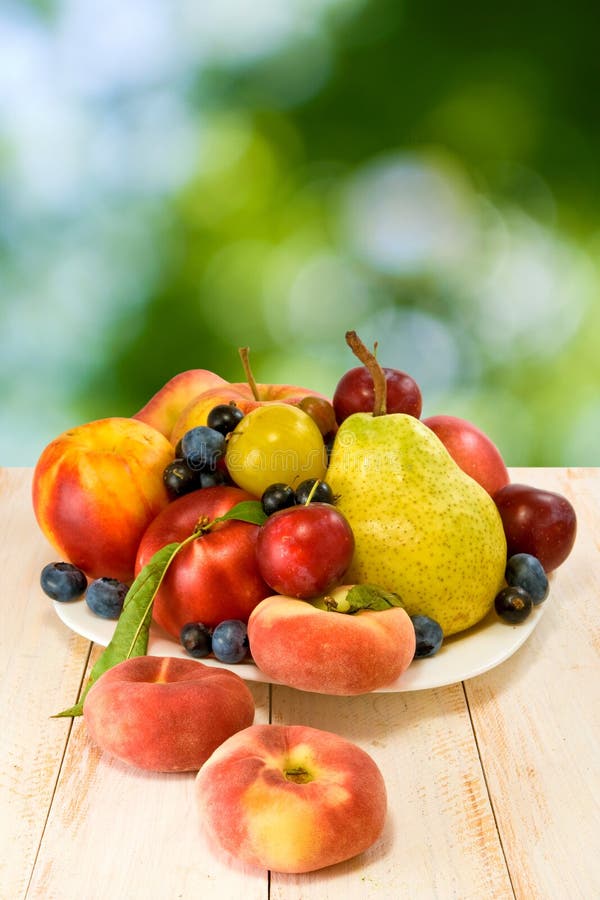 Image of Various Fruits on a Table on Green Background Stock Photo ...
