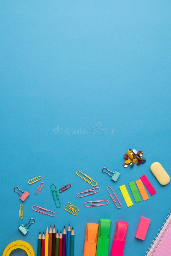 Image of Various Office Supplies, Pens, Paper Clips, Pins on Blue ...