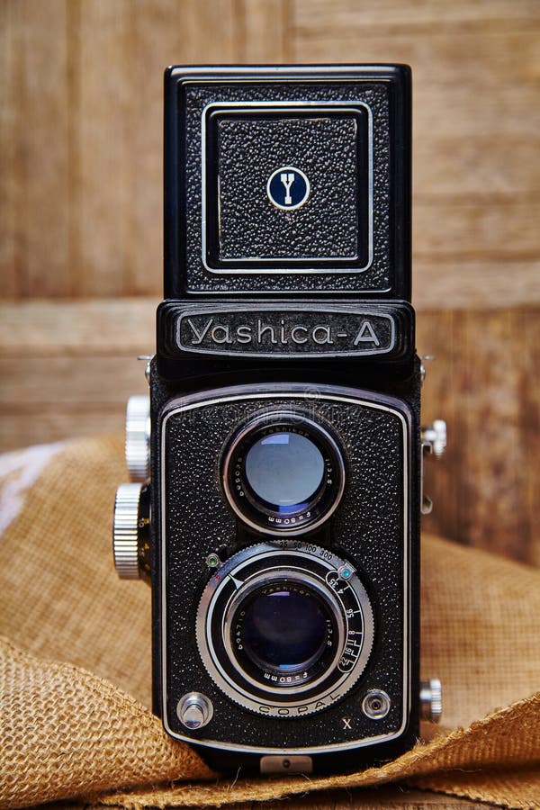 Very Old Style Camera on Top of Burlap Material in Front of a Wood Wall ...
