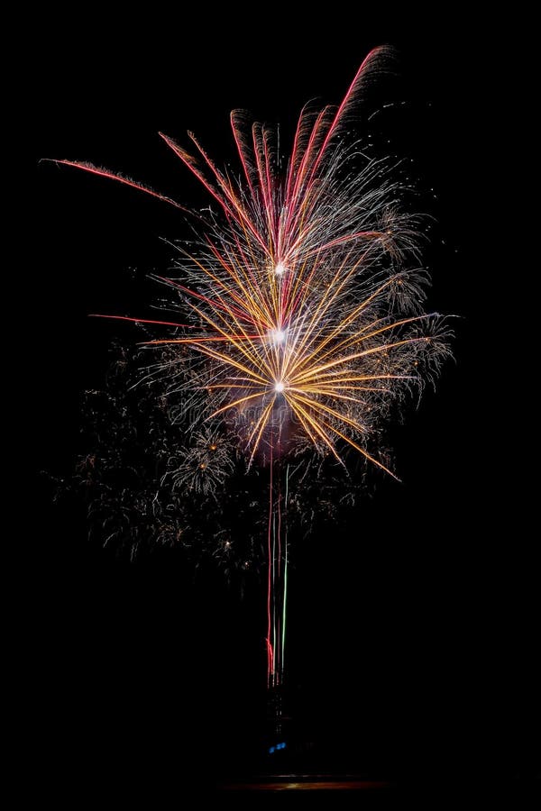 A Large Colorful Fireworks Exploding in the Night Sky Above Water Stock ...