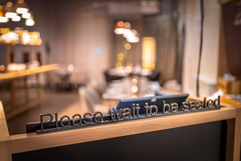 Wait To Be Seated Metal Sign in the Restaurant Stock Image - Image of ...