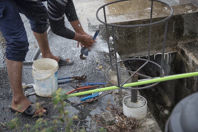 Washing Hand,legs and Plumbing Tools with the Burst Water Pipe ...