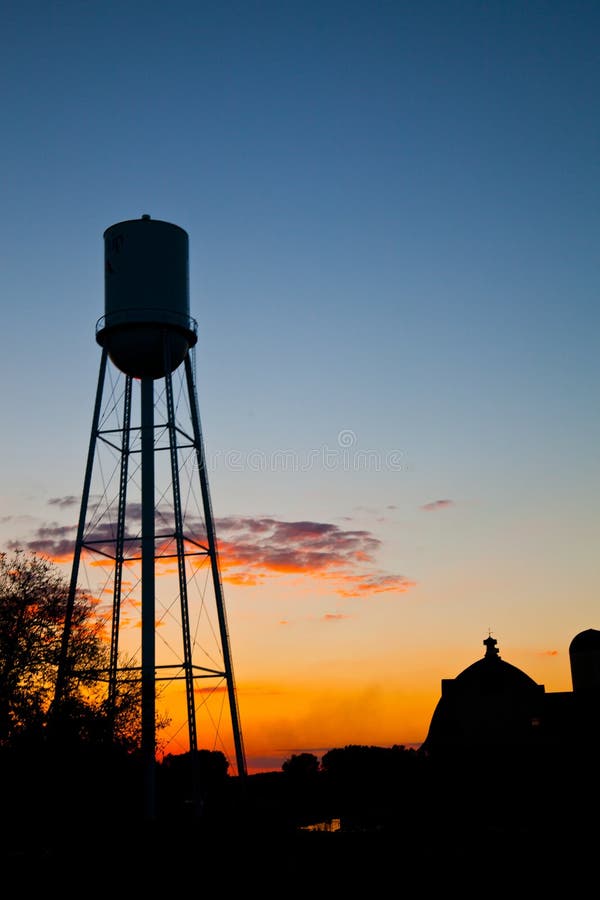 Water Tower and Barn Silhouetted Against the Setting Sunlight Stock ...