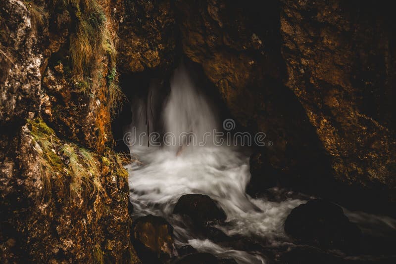 Water that is Flowing Out of a Cave with Moss on it Stock Photo - Image ...