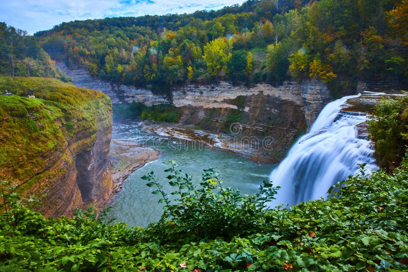 Waterfall from Side Pouring into Huge Canyon with Cliffs and Early Fall ...