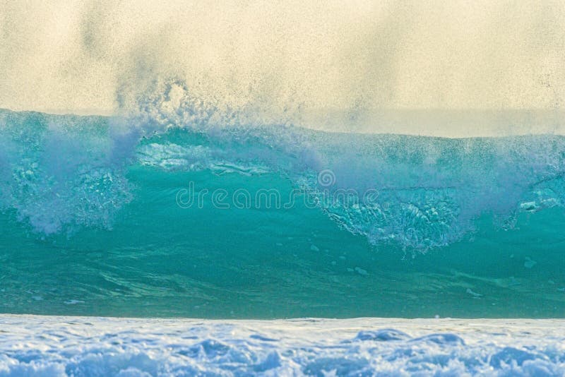Image of Wave Breaking on the Beach with Flying Spray and Turquoise ...