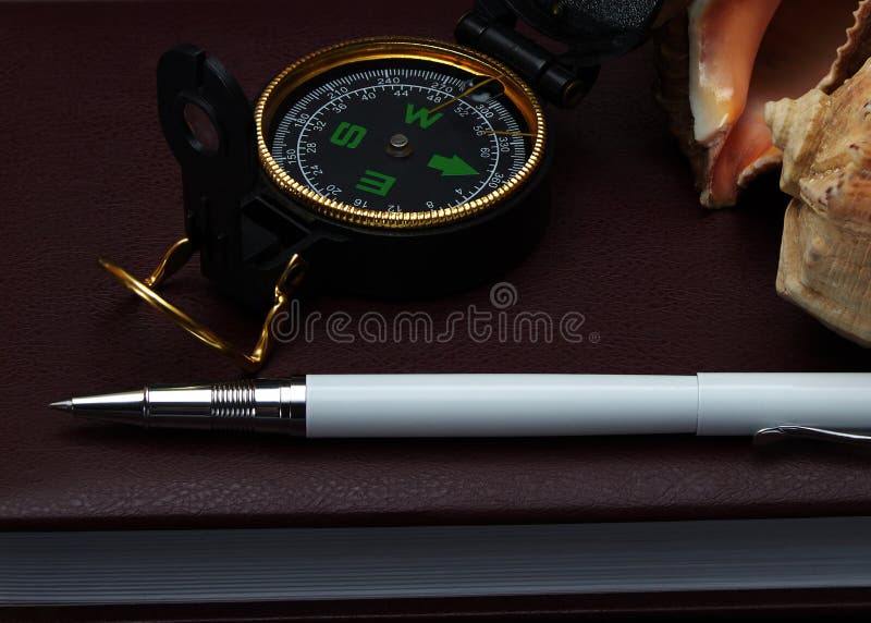 The Image on Which There is a Compass, a Seashell, a Pen and a Notebook ...