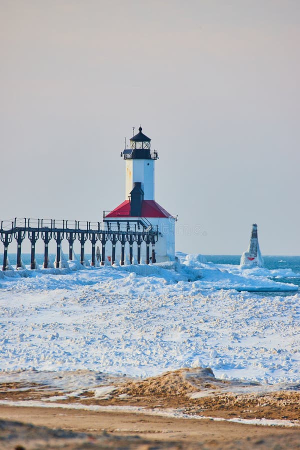 Winter View of Red and White Lighthouse on Beach Covered in Ice Stock ...