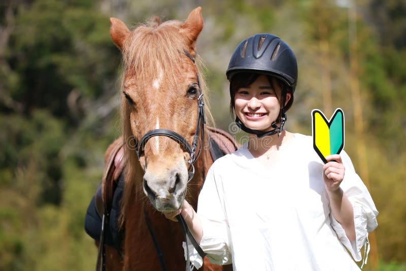 A Woman with a Beginner Mark Riding a Horse Stock Photo - Image of ...