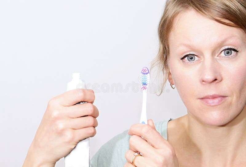 Woman brushing her teeth stock photo. Image of hygiene - 130571390