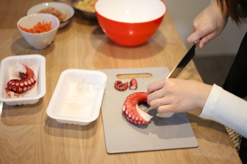Woman cutting octopus stock image. Image of japanese - 325393957