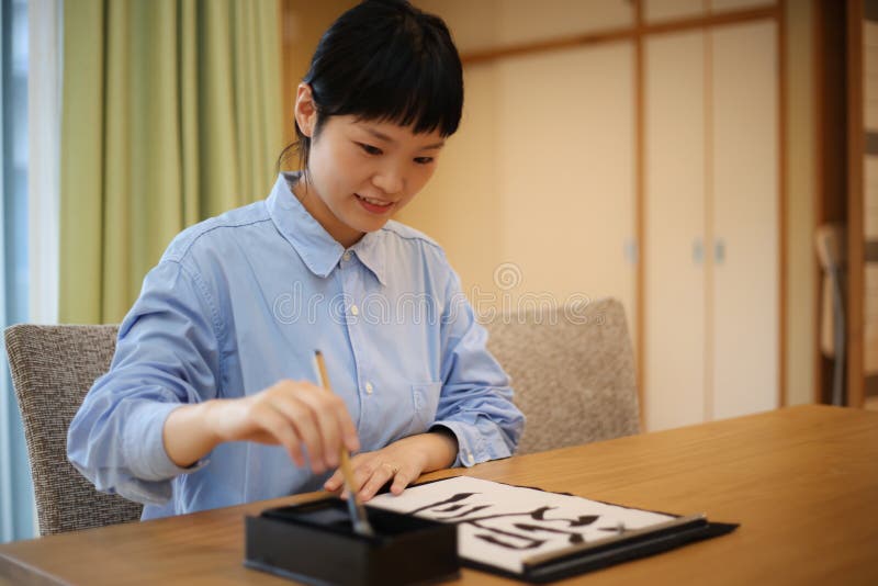 Woman doing calligraphy stock photo. Image of child - 244462356