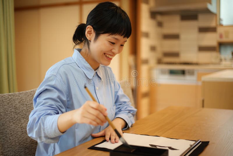 Woman doing calligraphy stock photo. Image of living - 244462360