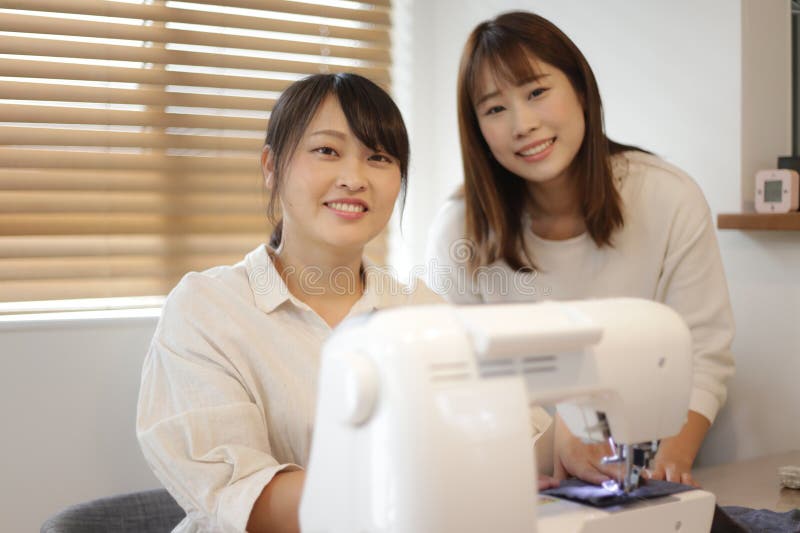 A Woman Learning How To Use a Sewing Machine Stock Photo - Image of ...