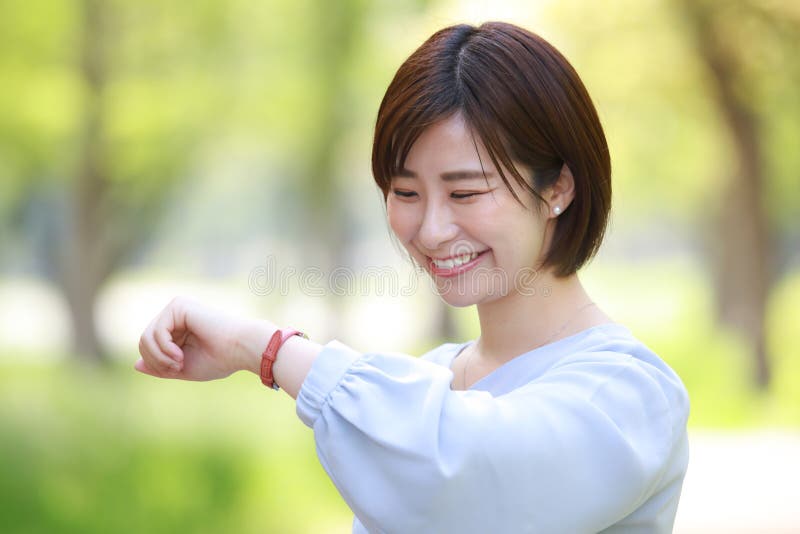 Woman looking at a watch stock photo. Image of business - 238944752