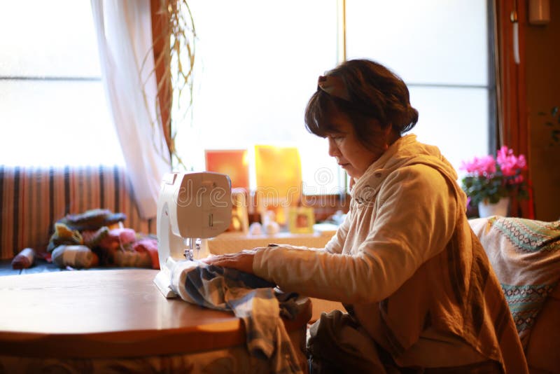 Woman Using a Sewing Machine Stock Photo - Image of beautiful, body ...