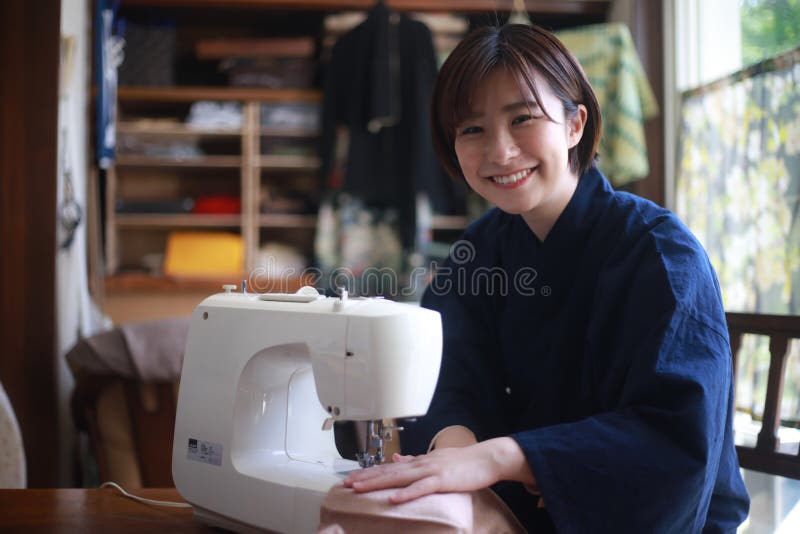 Female Using a Sewing Machine Stock Photo - Image of cute, cloth: 241189032