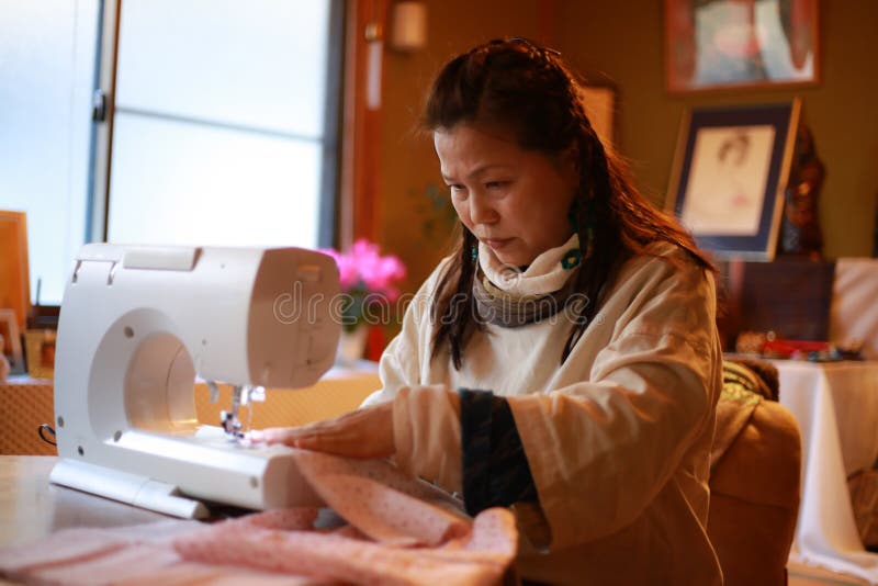 Woman Using a Sewing Machine Stock Image - Image of bright, clothes ...