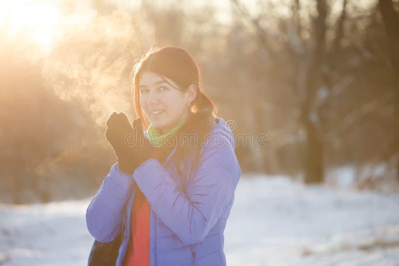 Image of Woman Warming Her Hands in Winter in Woods by Day. Stock Photo ...