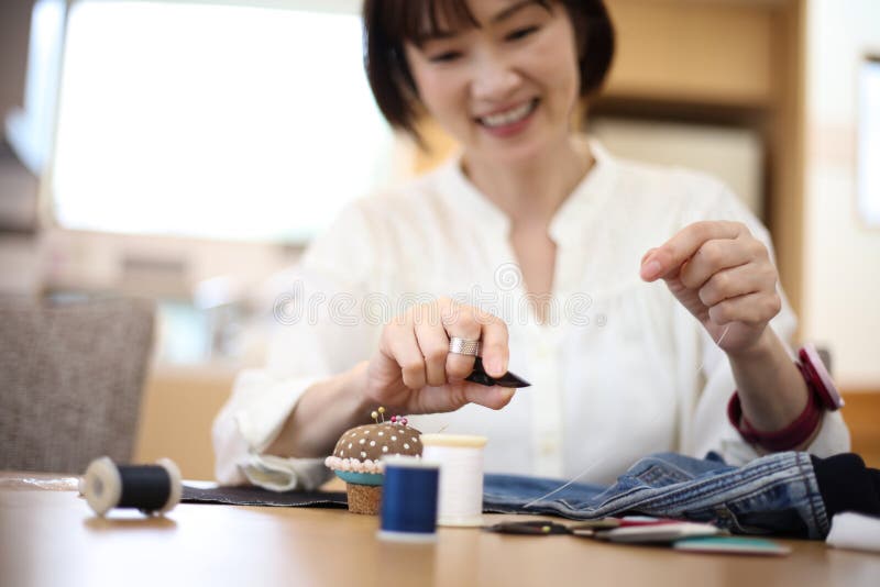 Woman cutting the thread stock photo. Image of close - 242526888