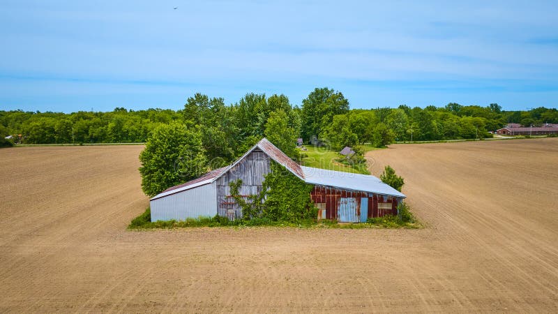 Wooden and Metal Barn Rusting with Three Empty Dirt Fields and a Patch ...