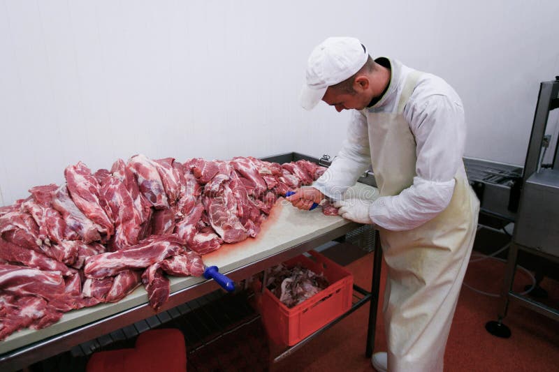 Image of a Worker in Meat Factory, Chopped a Fresh Beef Meat in Pieces ...