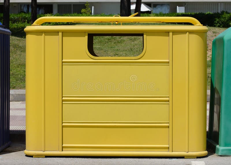 Yellow Plastic Garbage Can in the Street Stock Photo - Image of ...