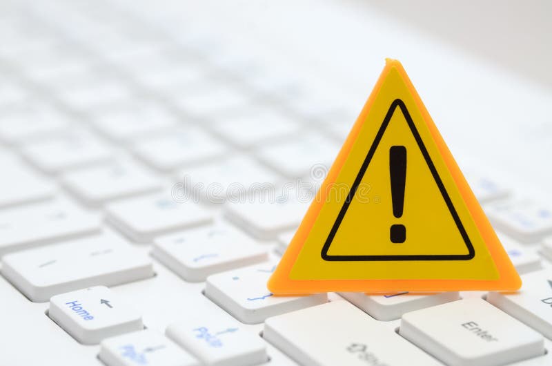 The Image of a Yellow Warning Sign on a Computer Keyboard Serves As a ...