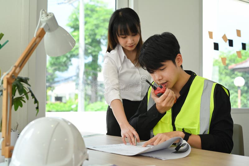 Image of Young Architects Collaborating, Discussing Building Plan ...