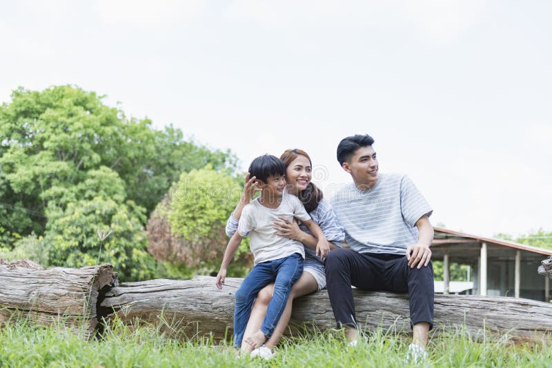 Image of Young Asian Family Playing Together at Park Stock Photo ...