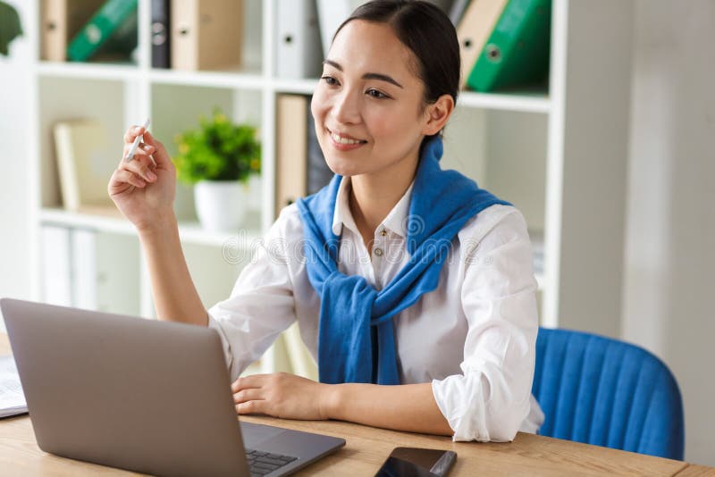 Image of Young Asian Woman Using Laptop Computer while Working in ...